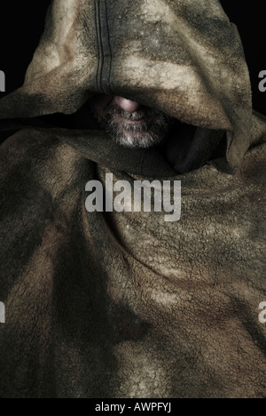 Hooded monk wearing cloak Stock Photo - Alamy