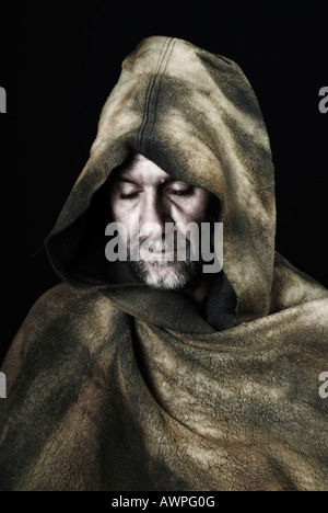 Hooded monk wearing cloak Stock Photo - Alamy