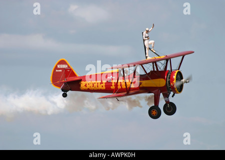 A Boeing PT17 Stearman biplane displaying with a wing walker between ...