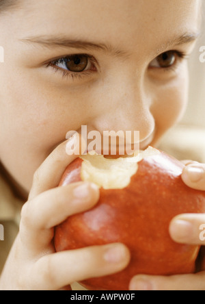 The girl eats apples with pleasure. Fruits for children. Portrait of a ...