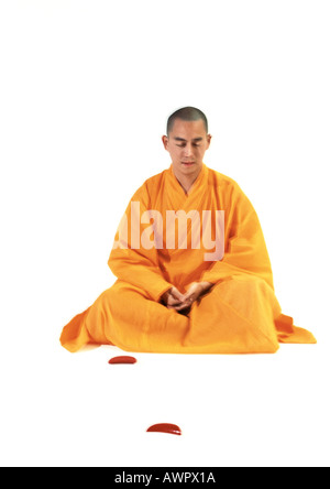 Meditating sitting buddhist tibetan monk in traditional ceremonial robe ...