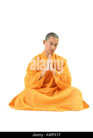 Meditating sitting buddhist tibetan monk in traditional ceremonial robe ...