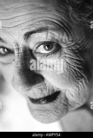 High angle portrait of black senior woman cutting vegetables in cozy ...