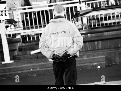 Rear View Of Security Guards With Hands Behind Back Standing In A Row ...