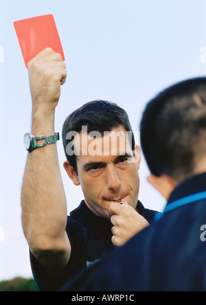 Referee showing a red card to a displeased football or soccer player ...