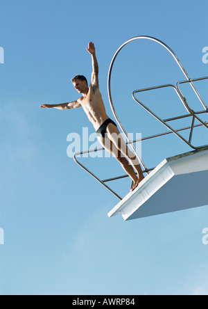 Low angle shot of a man diver is diving in the deep of great blue ocean ...