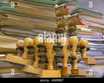 desk with stamps and lots of files folders and documents working in ...