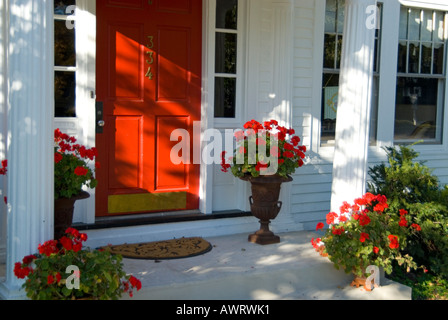 Red Front Door & Potted Geraniums at home entrance Stock Photo - Alamy
