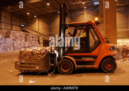 Forklift moving bales of waste paper ready for recycling Stock Photo ...