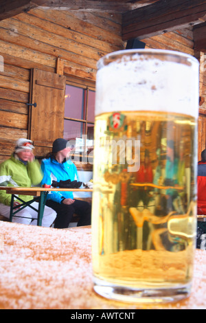 drinking drink beer outside Apres ski Wintersport in the mountains of ...