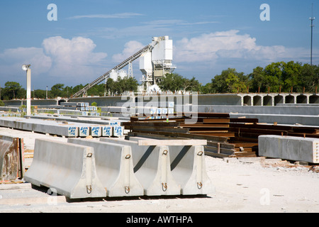 Concrete batch plant behind precast concrete products and forms at ...