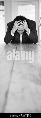 Frustrated and desperate man holding hands on head, looking sad and ...