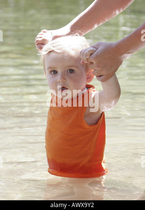 Boy (6-7) wading in water Stock Photo - Alamy
