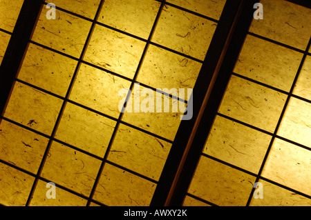 Sliding shoji paper screen panels divide the interior space of the ...