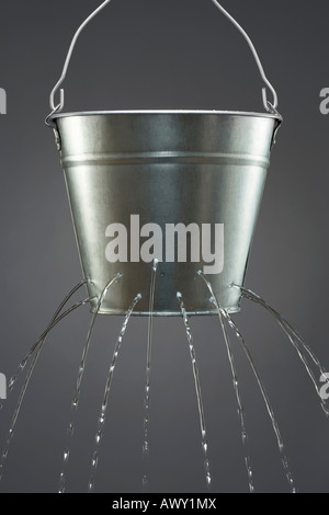 leaking bucket of water Stock Photo - Alamy