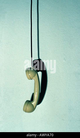 Phone call concept: a phone receiver dangling with copy space Stock ...