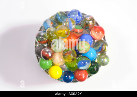 High angle shot of colorful marbles and corn kernels on an orange ...