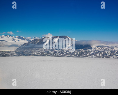 An aerial shot of snowy dry scenery on the road 520 between Sauda and ...