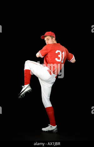 Pitcher Baseball Player on a Red Uniform on red lights background Stock ...