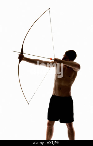 Silhouette of archer pulling an arrow back on his longbow Stock Photo ...
