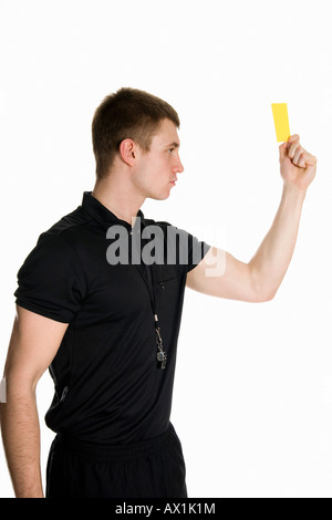 Referee holding up a yellow card Stock Photo - Alamy