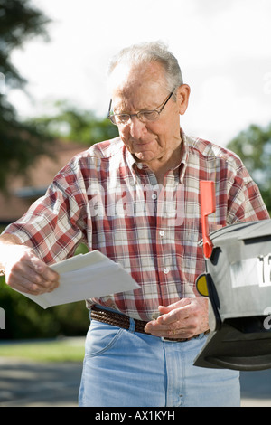 Senior man checking his mailbox Stock Photo - Alamy
