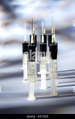 Multiple syringes with coloured background Stock Photo - Alamy