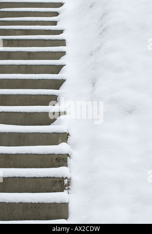 Snow covered slippery concrete stairs. First snow on granite stone ...