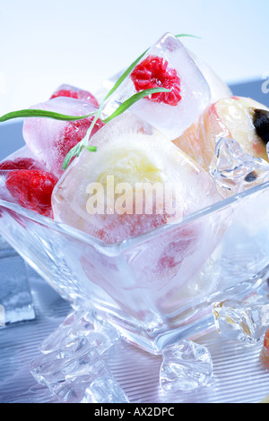 Frozen apricot and raspberries into a broken ice cubes Stock Photo - Alamy