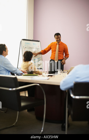 African American man giving presentation to colleagues at international ...