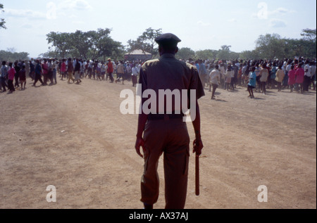 Police control refugees eager to get to a weekly food distribution at ...