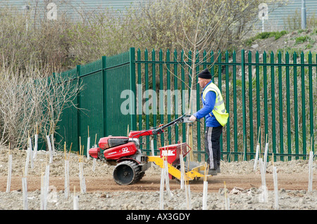 man operating a machine to level ground on a construction site in the ...