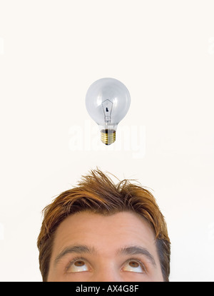 Young man having brilliant idea to come up in mind while reading smart ...