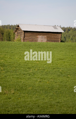 An old wooden barn in a Finnish farmstead during a colorful autumn near ...
