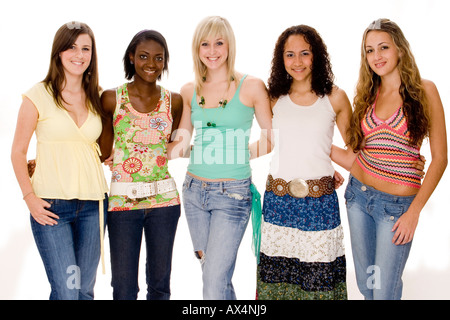 A group of five attractive young women in casual outfits on white ...
