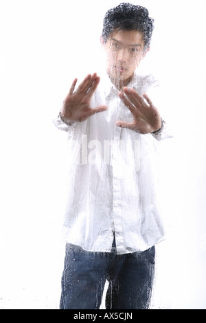 Young Man Standing at Window in Confident Pose Looking at City Stock ...