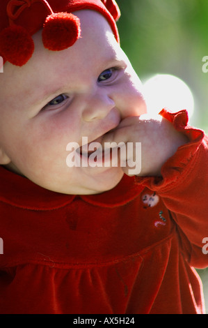 baby in red outfit on stomach Stock Photo - Alamy
