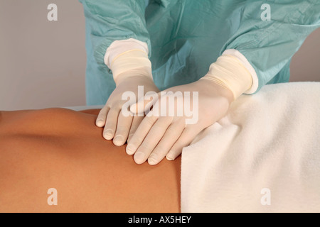Abdominal examination, Doctor is examining the abdomen of patient Stock ...