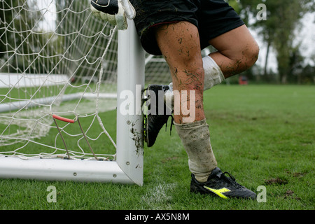 Goalkeeper at the goal post Stock Photo - Alamy