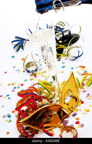 bottle of champagne with glasses and colorful confetti on colored ...