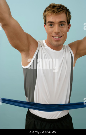 A male sprinter breaking tape, crossing finish line Stock Photo - Alamy