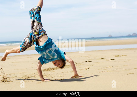 Boy doing a cartwheel Stock Photo: 11365424 - Alamy