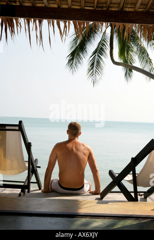 Man alone beach. Solitary man overlooking the beach and ocean at ...
