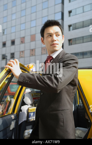 Man is stepping out of car, portrait Stock Photo - Alamy