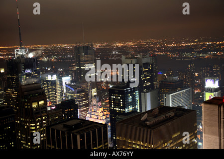 A night time view of building tops in New York City, from midtown area ...