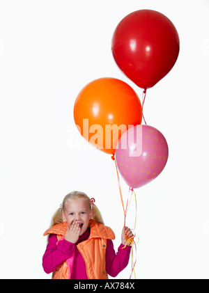 Funny girl holding hair plaits. Small cute girl with long blonde hair ...