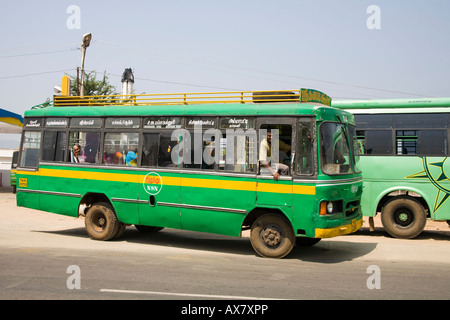 Indian bus / coach traveling along a tree lined road in the countryside ...