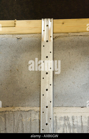 metal straps to hold down wall plate and roof structure onto Stock ...