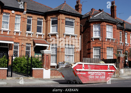 Skip outside house in London, England Stock Photo - Alamy