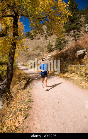 one man running on a trail at a rainforest Stock Photo - Alamy